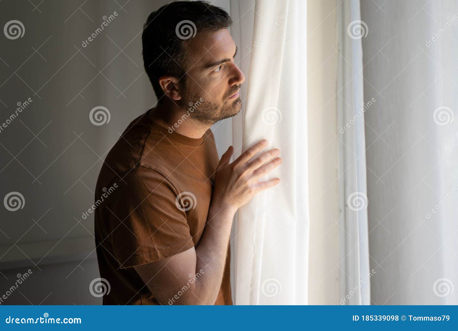Portrait of One Guy Longing and Looking through Window Stock Photo ...