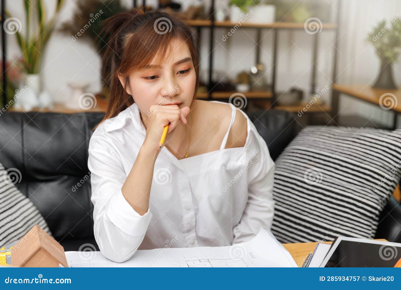 Thoughtful Architect Female Holding a Pencil and Thinking Over ...