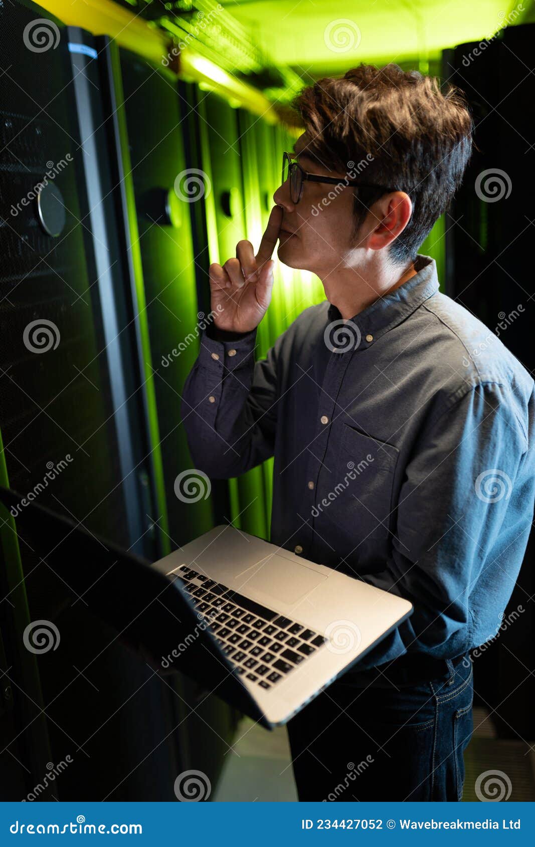 Thoughtful Asian Male Engineer with Laptop Inspecting in Computer ...