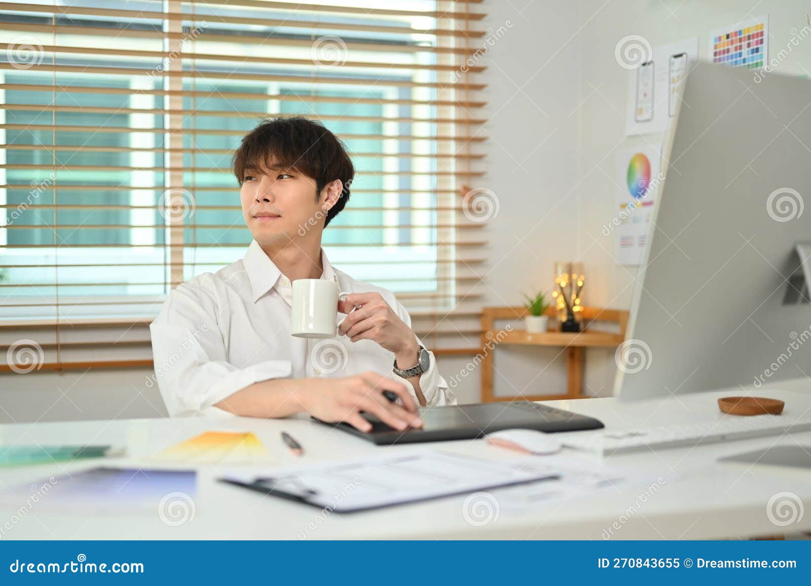 Thoughtful Asian Man Web Developer Drinking Coffee and Looking through ...