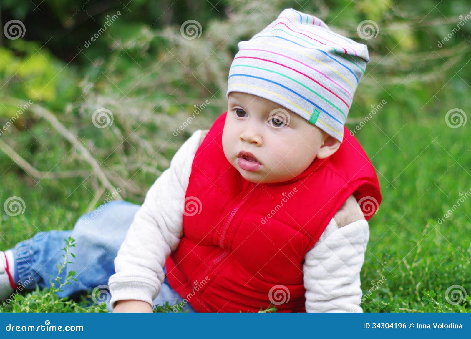 Thoughtful Baby Sitting on Grass Outdoors Stock Photo - Image of green ...
