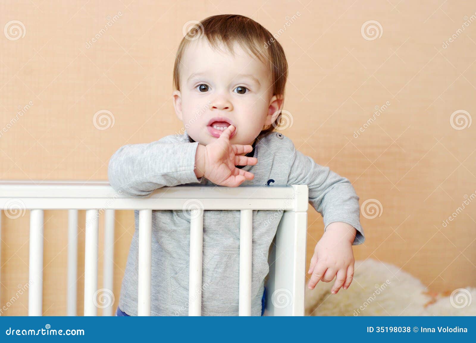 Thoughtful Baby in White Bed Stock Photo - Image of caucasian, finger ...