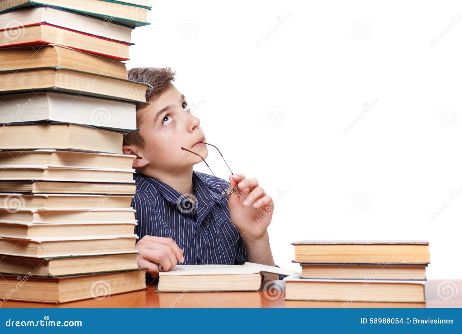 Thoughtful Boy Looking Up and Dreaming of a Books Stack on White ...