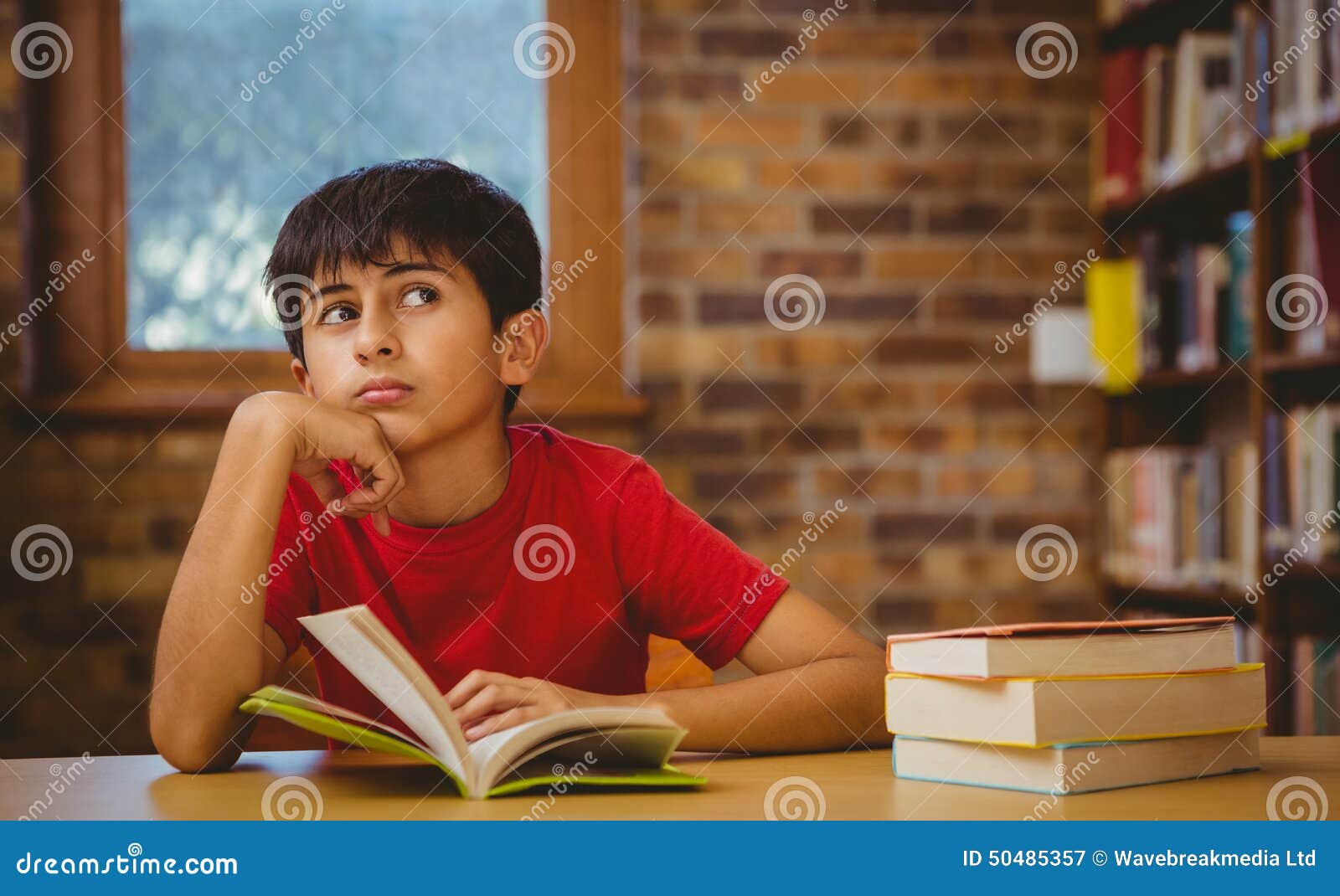 Thoughtful Boy Reading Book in Library Stock Image - Image of cute ...