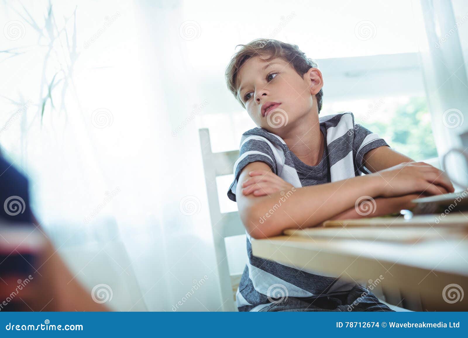 Thoughtful Boy Sitting on Chair Stock Photo - Image of homey, indoors ...