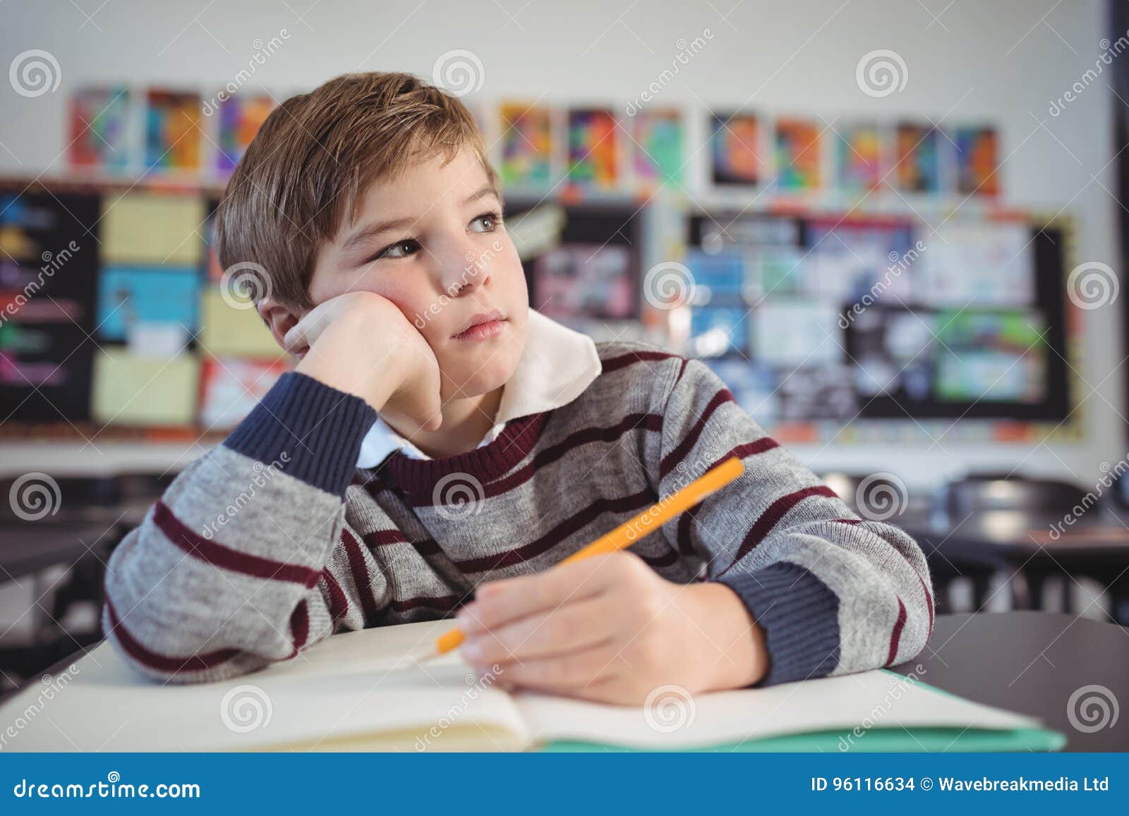 Thoughtful Boy Studing while Sitting at Desk Stock Photo - Image of ...