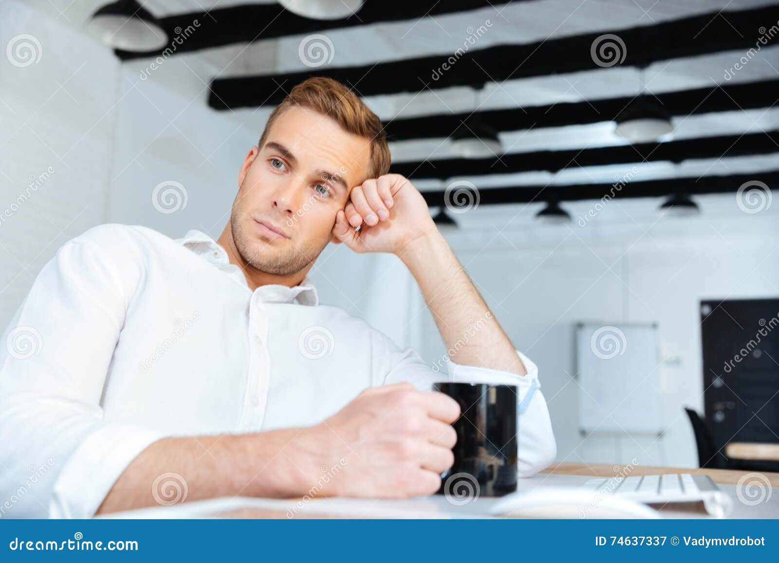 Thoughtful Businessman Drinking Coffee and Thinking at Workplace Stock ... Thoughtful Businessman Drinking Coffee and Thinking at Workplace Stock ...