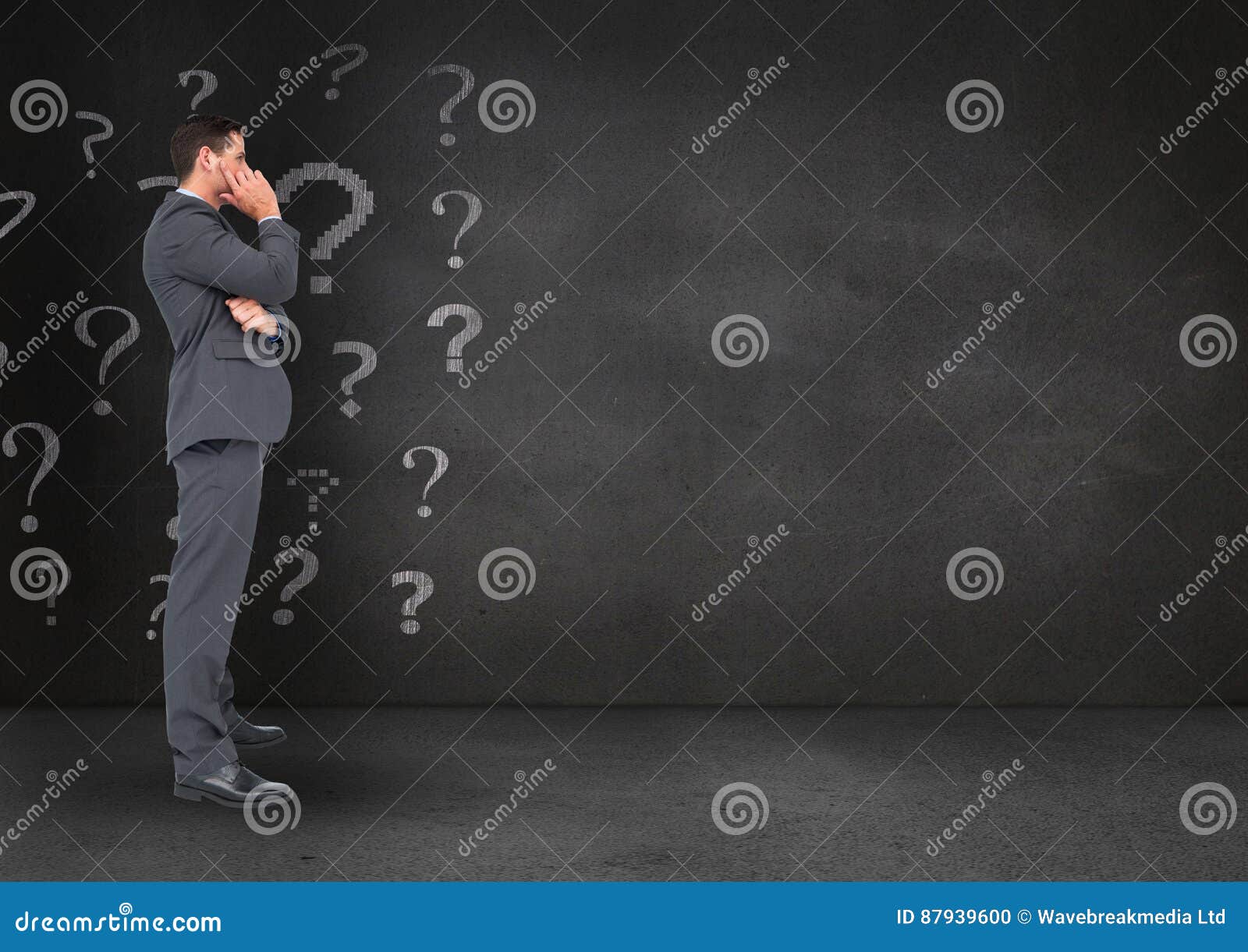 Thoughtful Businessman Standing with Question Marks in Background Stock ...