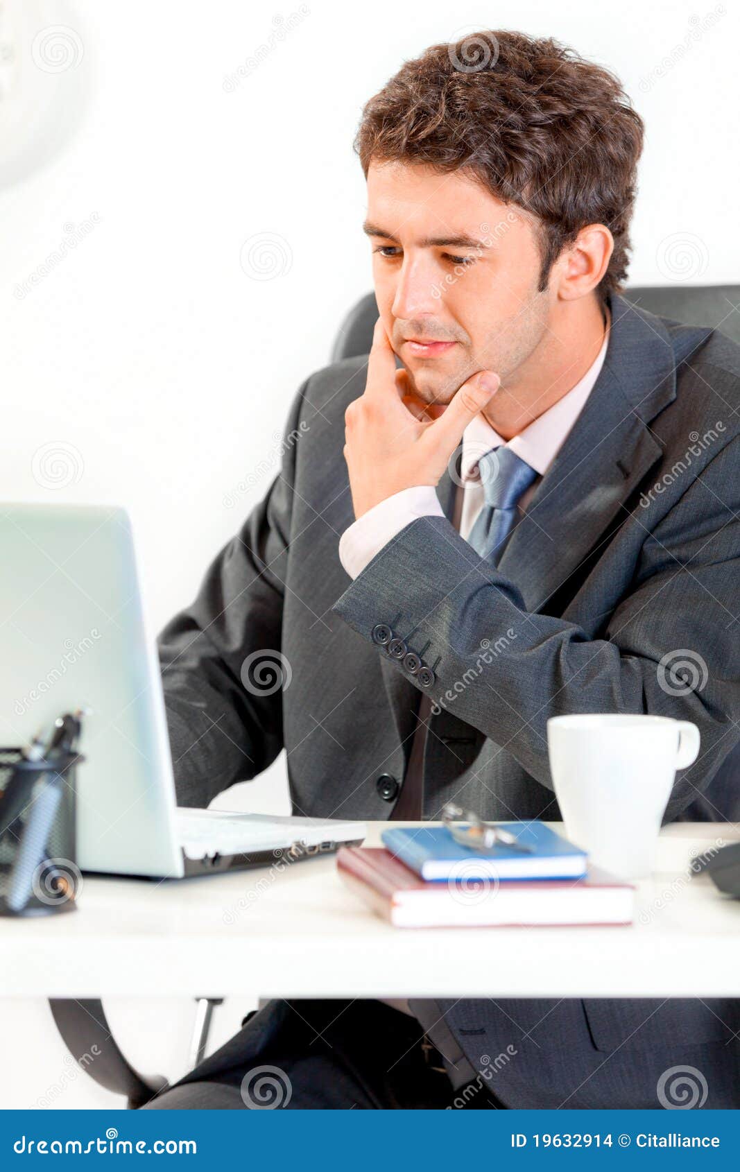 Thoughtful Businessman Working on Laptop in Office Stock Photo - Image ...