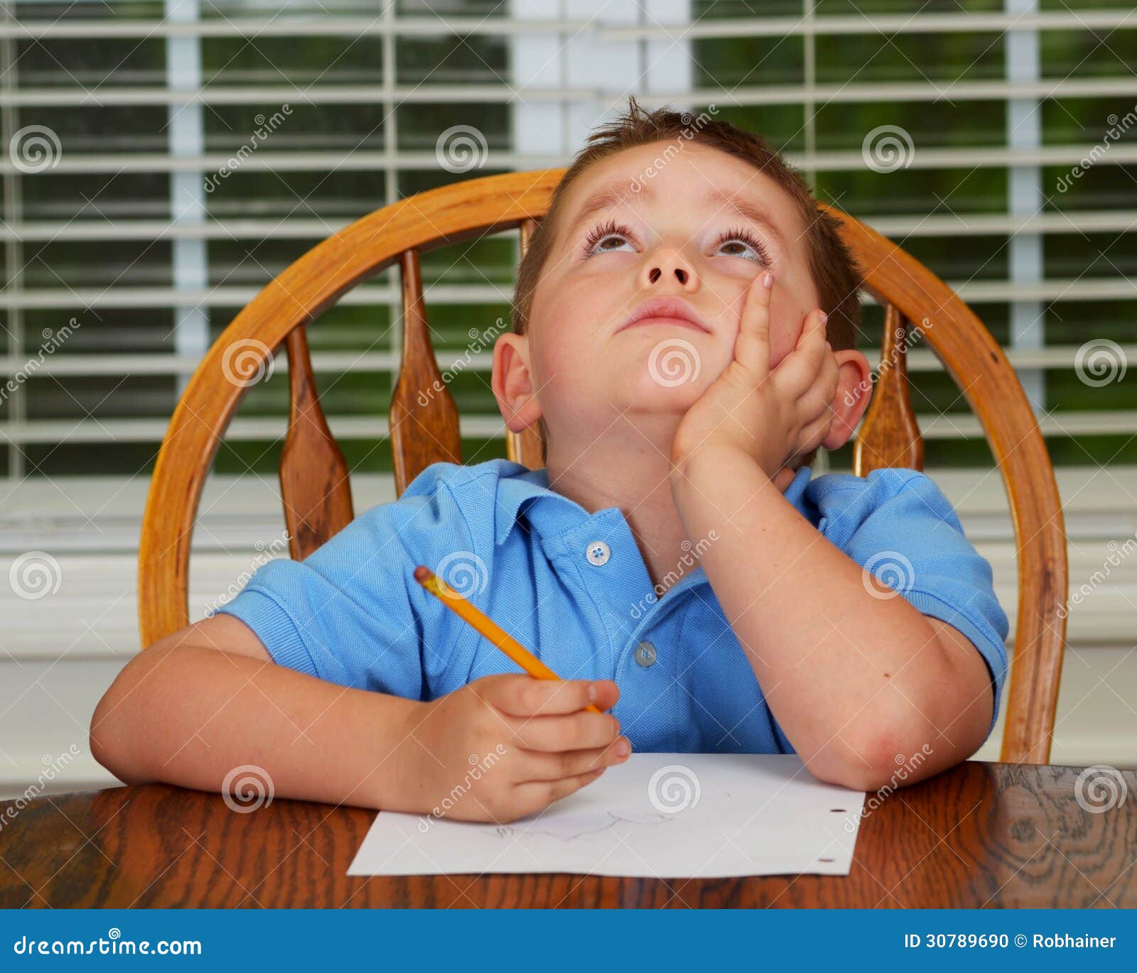 Thoughtful Child Doing His Homework Stock Photo - Image of dreaming ...