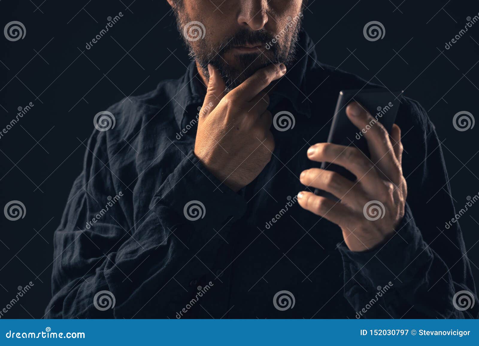 Thoughtful Concerned Man is Reading Text Message on Smartphone Stock ... Thoughtful Concerned Man is Reading Text Message on Smartphone Stock ...