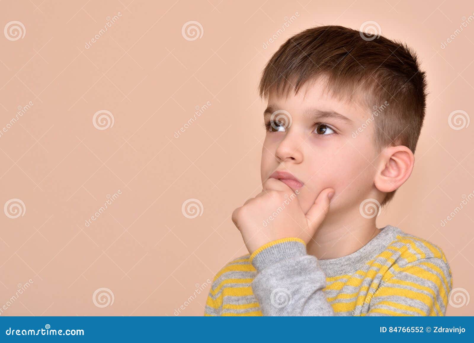 Thoughtful cute young boy stock photo. Image of inspiration - 84766552