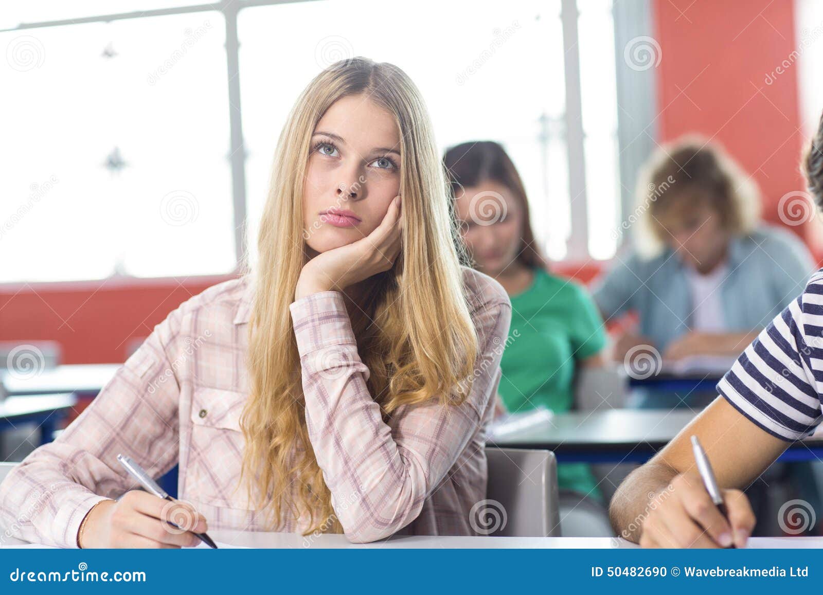 Thoughtful Female Student in Classroom Stock Photo - Image of looking ...