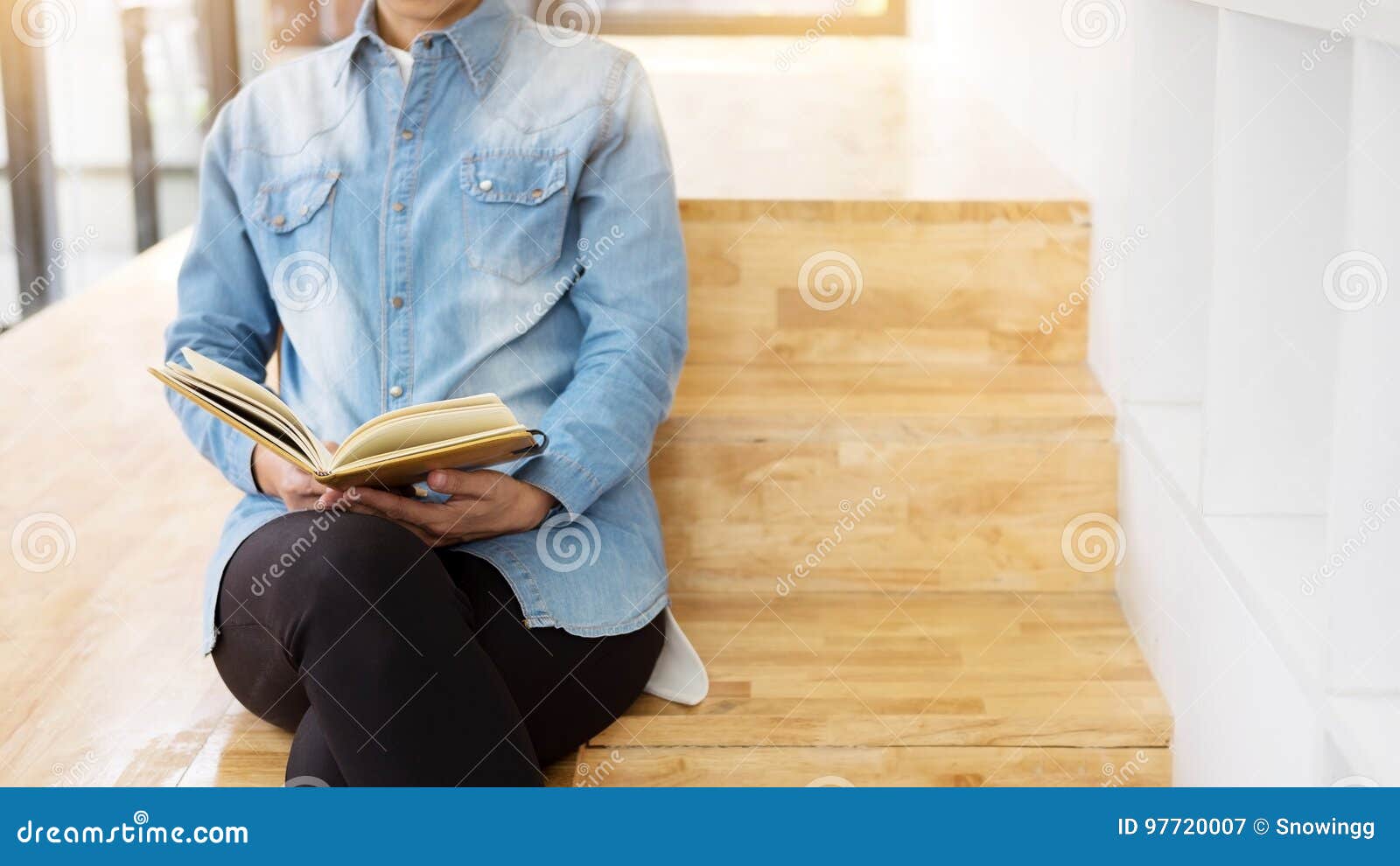 Thoughtful Female Student Sitting Serious Reading a Book in a Li Stock ...