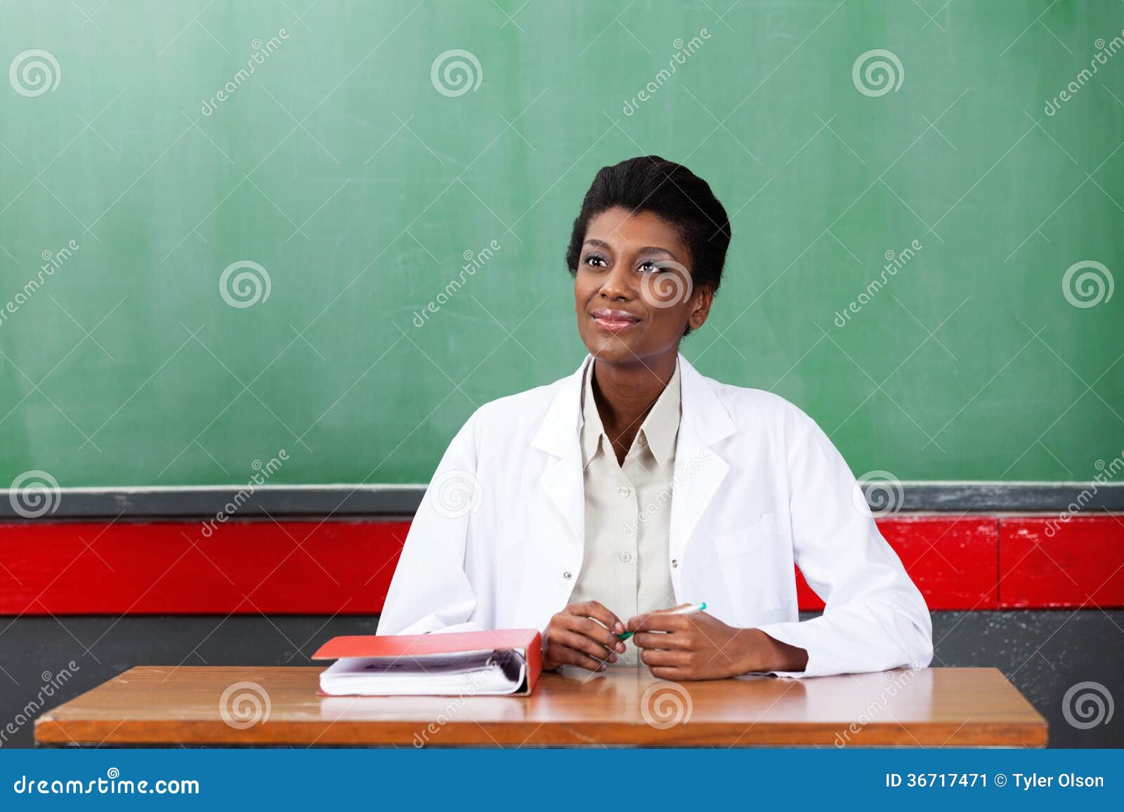 Thoughtful Female Teacher Sitting At Desk In Stock Image Image Of