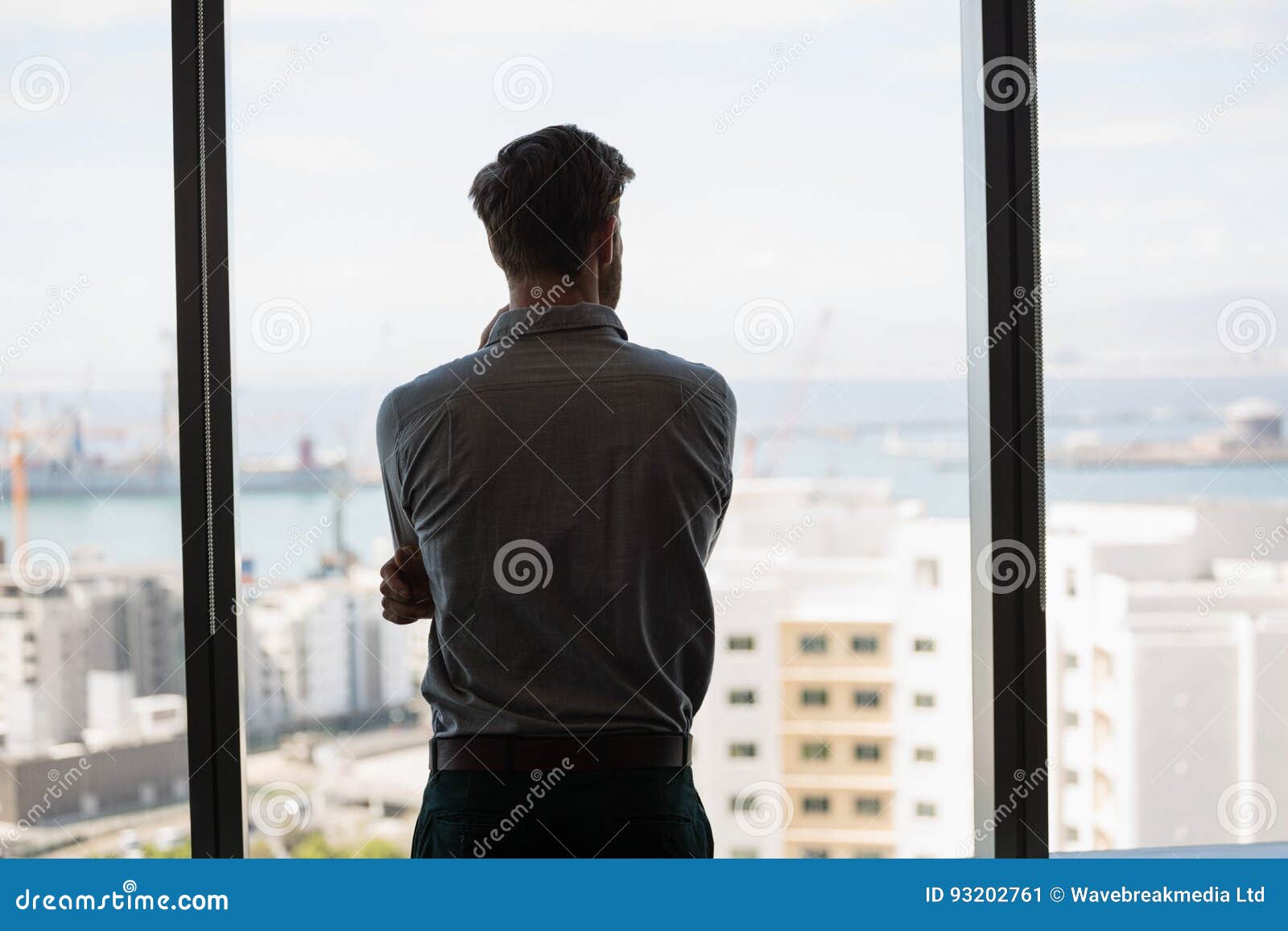 Thoughtful Male Executive Looking through Window in Office Stock Image ...