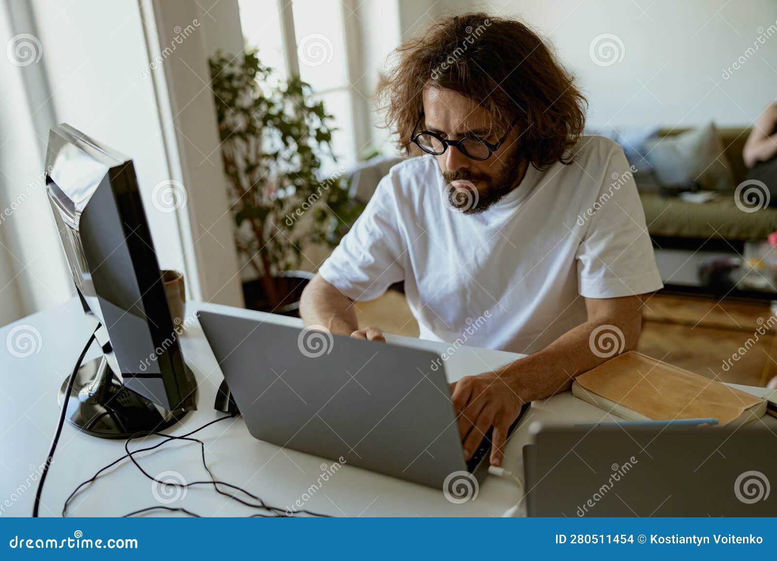 Thoughtful Man Freelancer Sitting at Desk and Working at Laptop and ...