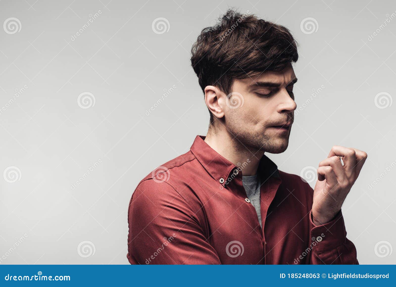 Thoughtful Man Looking at Hand Isolated on Grey Stock Image - Image of ...