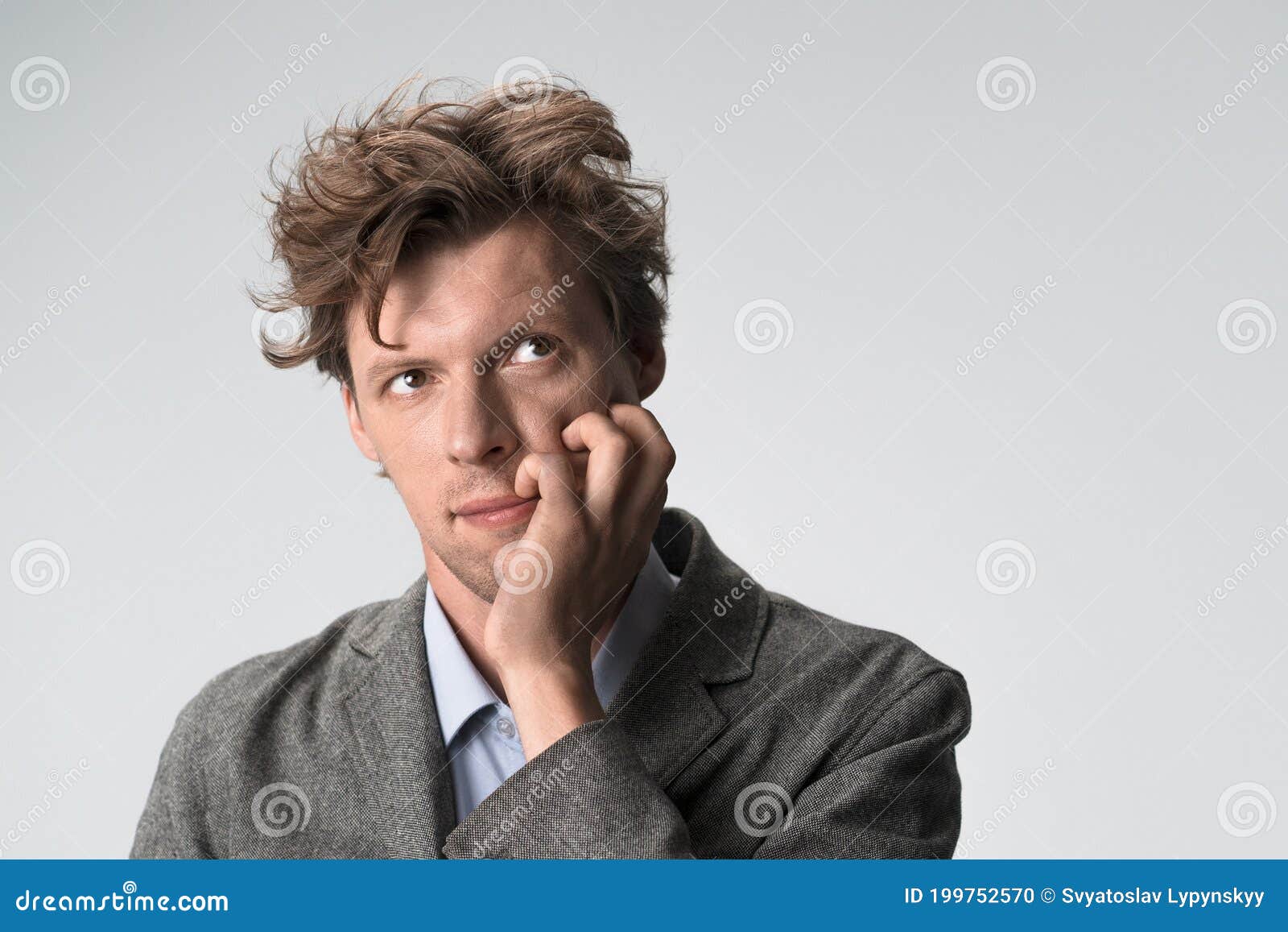 Thoughtful Man Looking Up To Side Grabbing His Face with His Hand. Copy ...