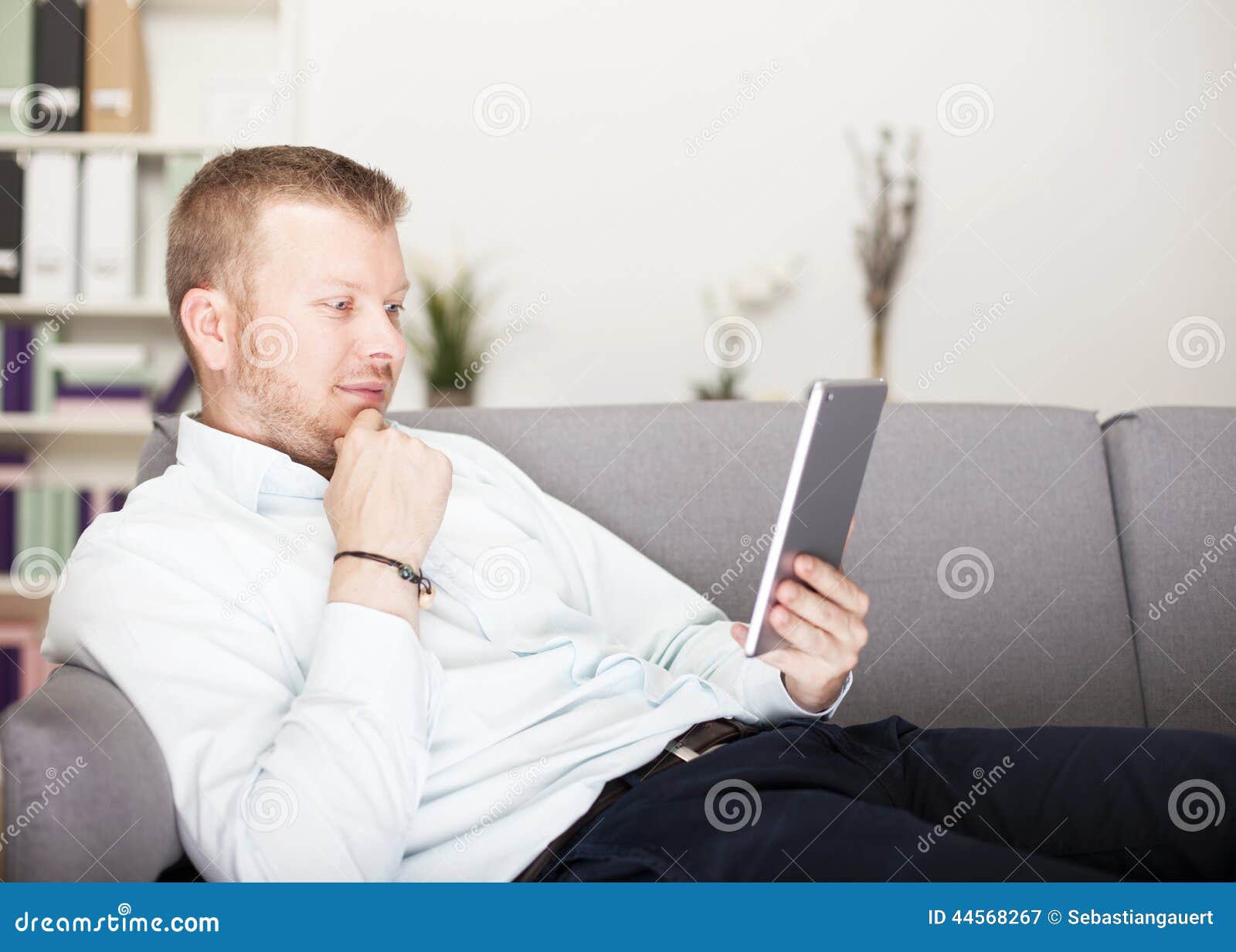Thoughtful Man Reading His Tablet Computer Stock Image - Image of ...