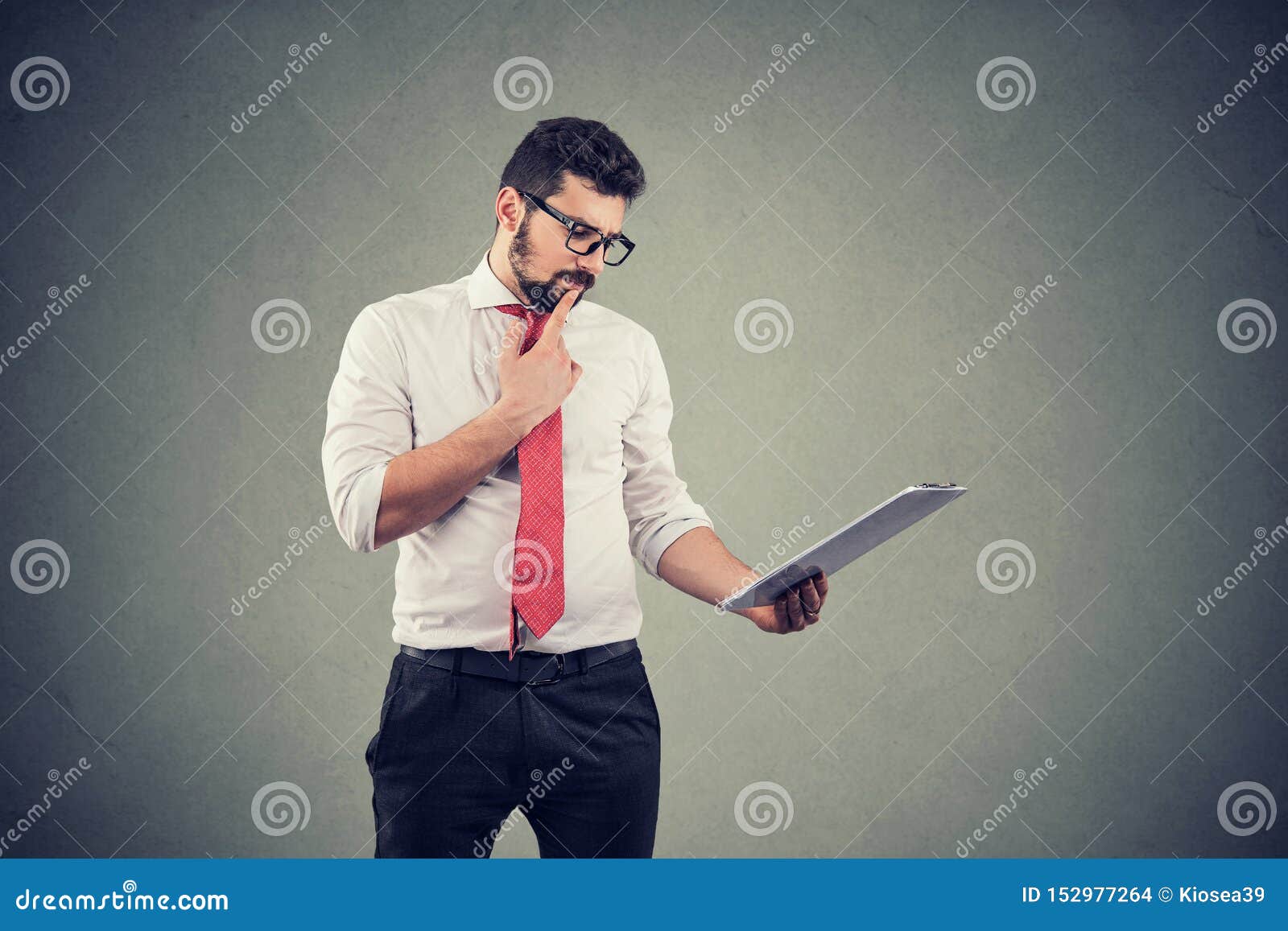 Thoughtful Man Touching Chin and Using Tablet Computer Stock Photo ... Thoughtful Man Touching Chin and Using Tablet Computer Stock Photo ...