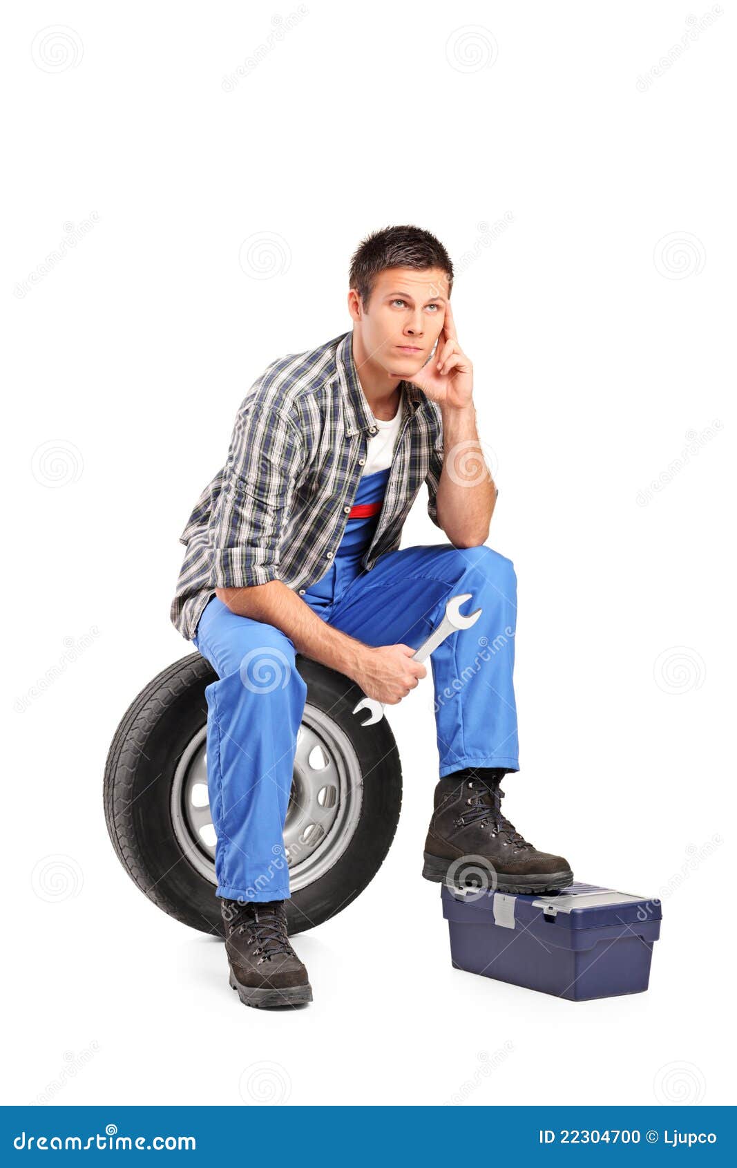 A Thoughtful Mechanic Sitting on a Tire Stock Photo - Image of problem ...