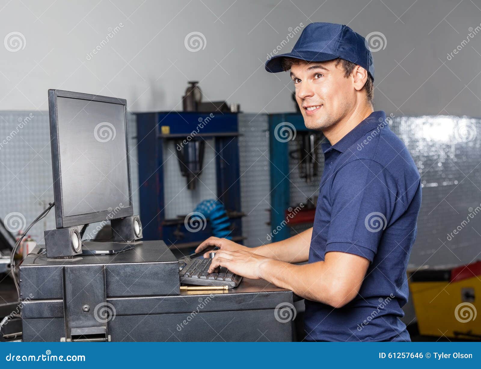 Thoughtful Mechanic Using Computer in Repair Shop Stock Photo - Image ...