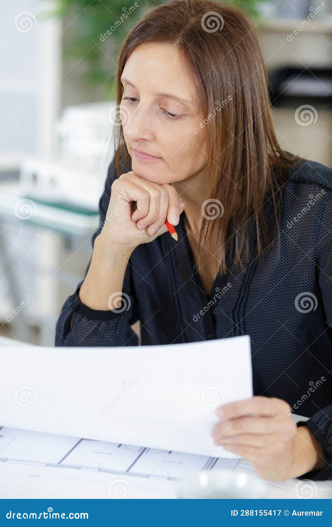 Thoughtful Middle-aged Female Engineer Looking at Plans Stock Image ...