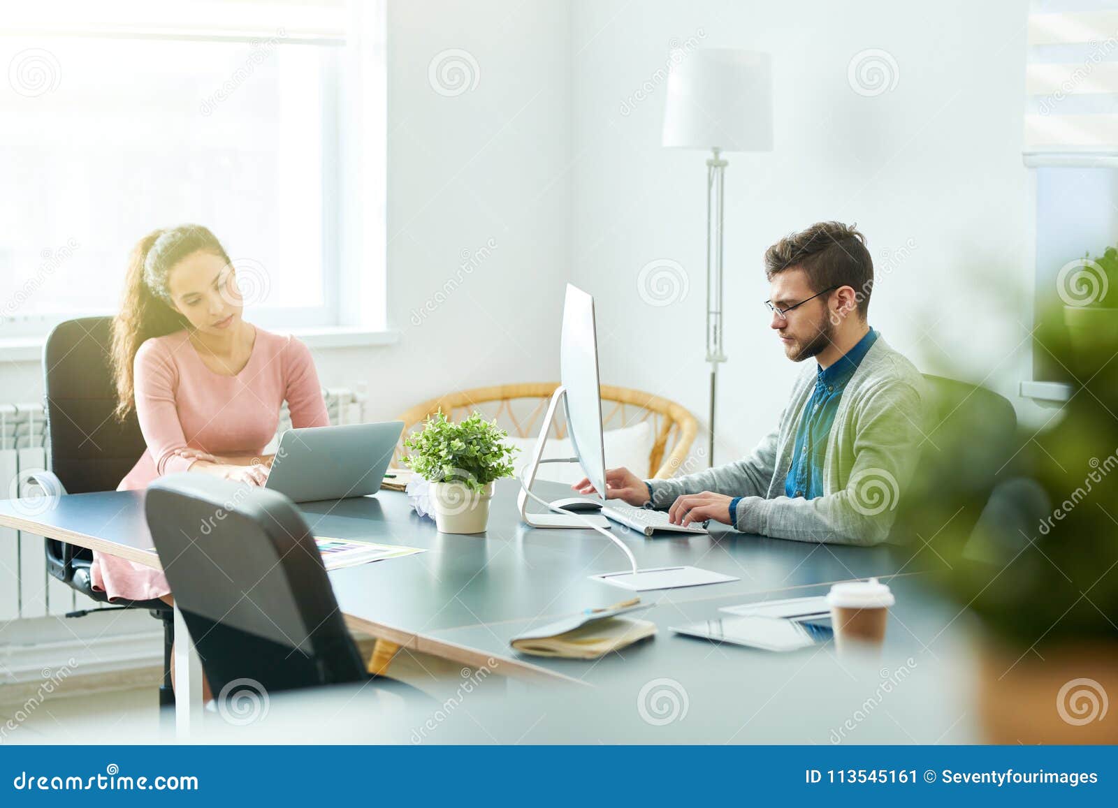 Thoughtful Office Colleagues Using Computers Stock Image - Image of ...