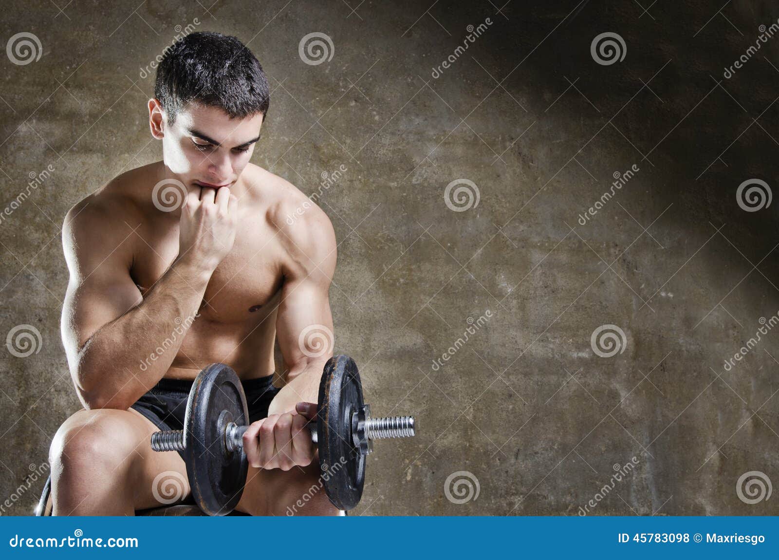 Thoughtful and Relaxed Man Training with Dumbbell Stock Photo - Image ...