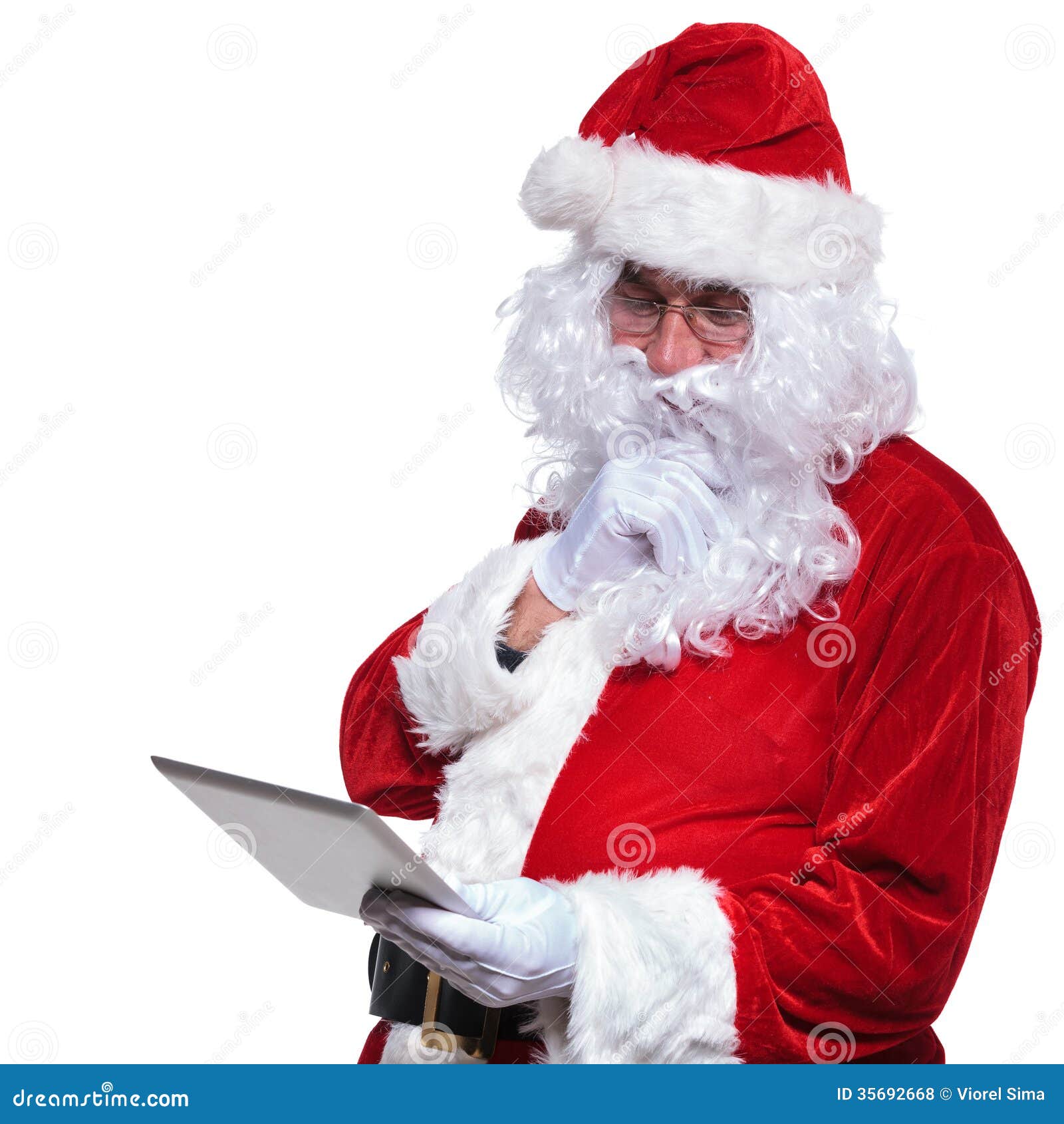Thoughtful Santa Claus Reading Wishes on Tablet Pad Stock Photo - Image ...