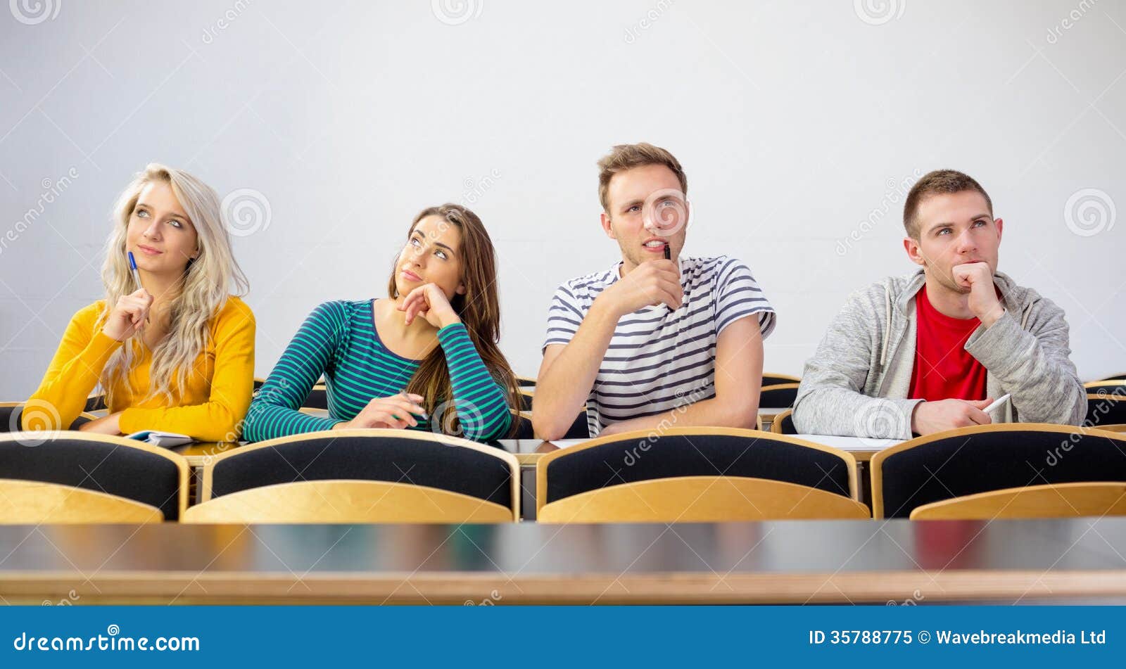 Thoughtful Smiling College Students in Classroom Stock Image - Image of ...