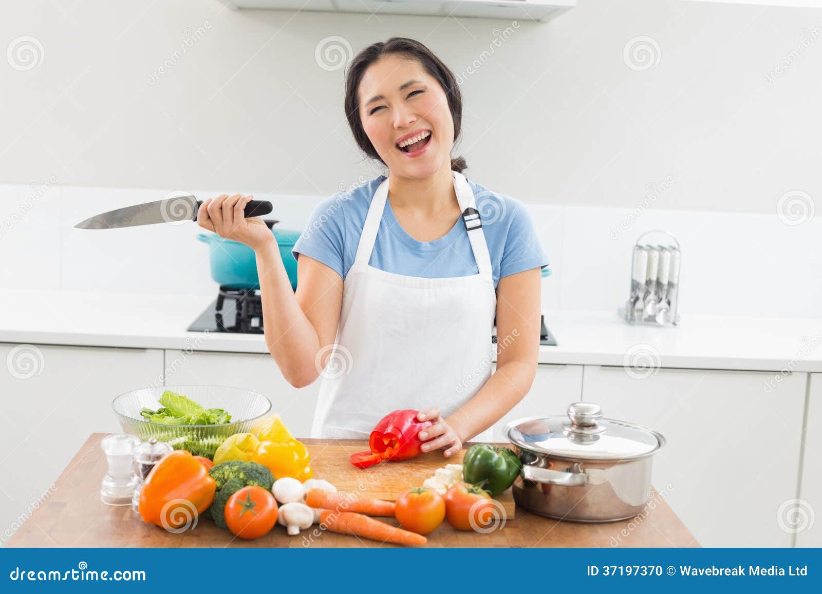 Thoughtful Smiling Woman Chopping Vegetables in Kitchen Stock Photo ...