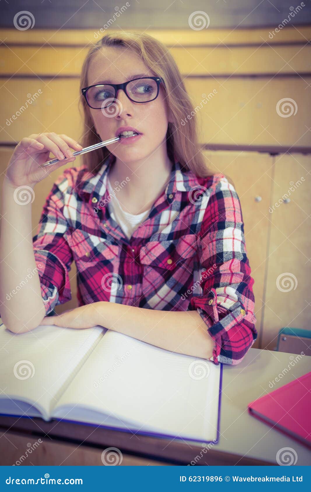 Thoughtful Student Biting Pen Stock Photo - Image of focused, campus ...