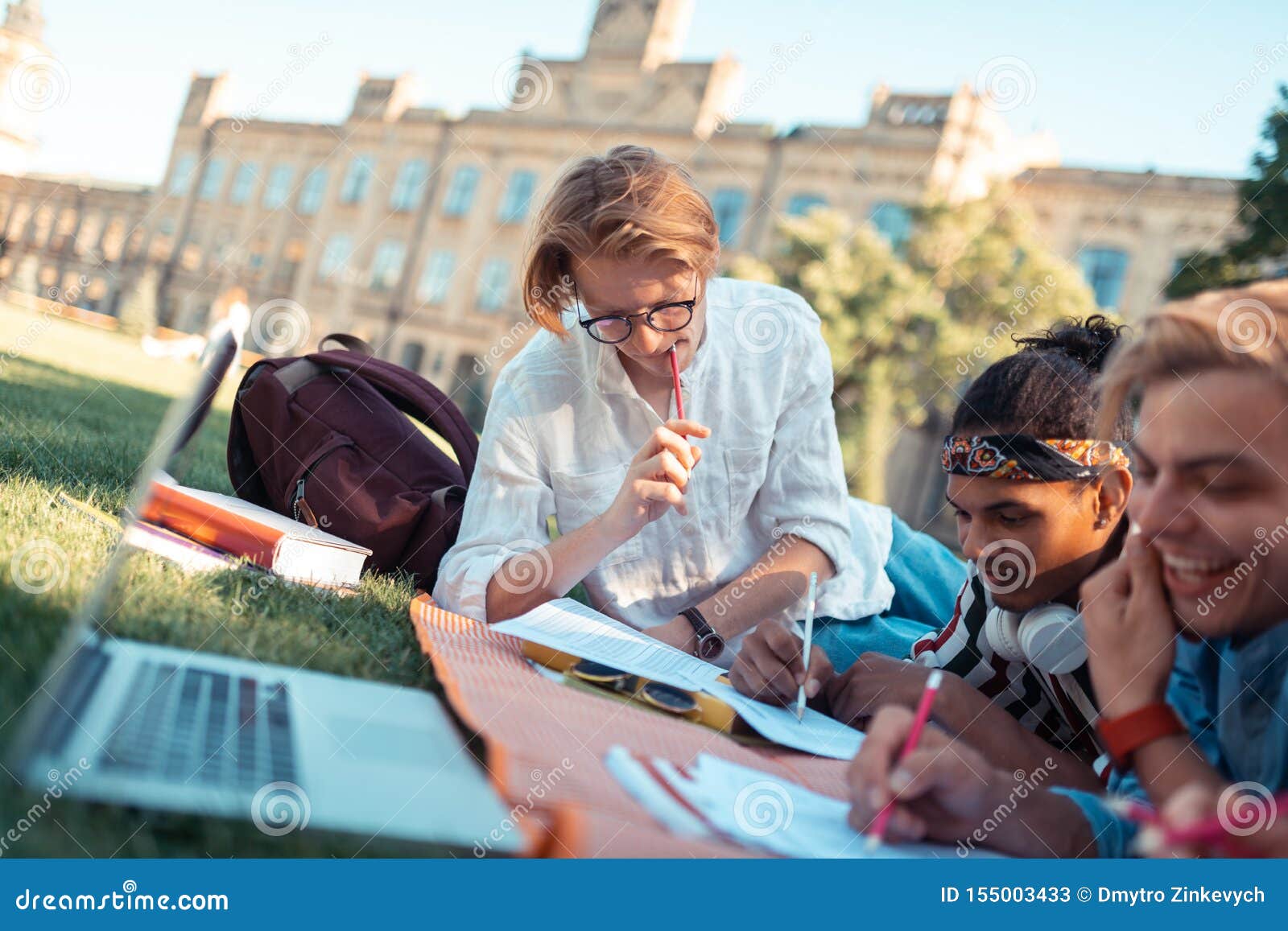 Thoughtful Student Solving Maths Problem with His Friends. Stock Image ...