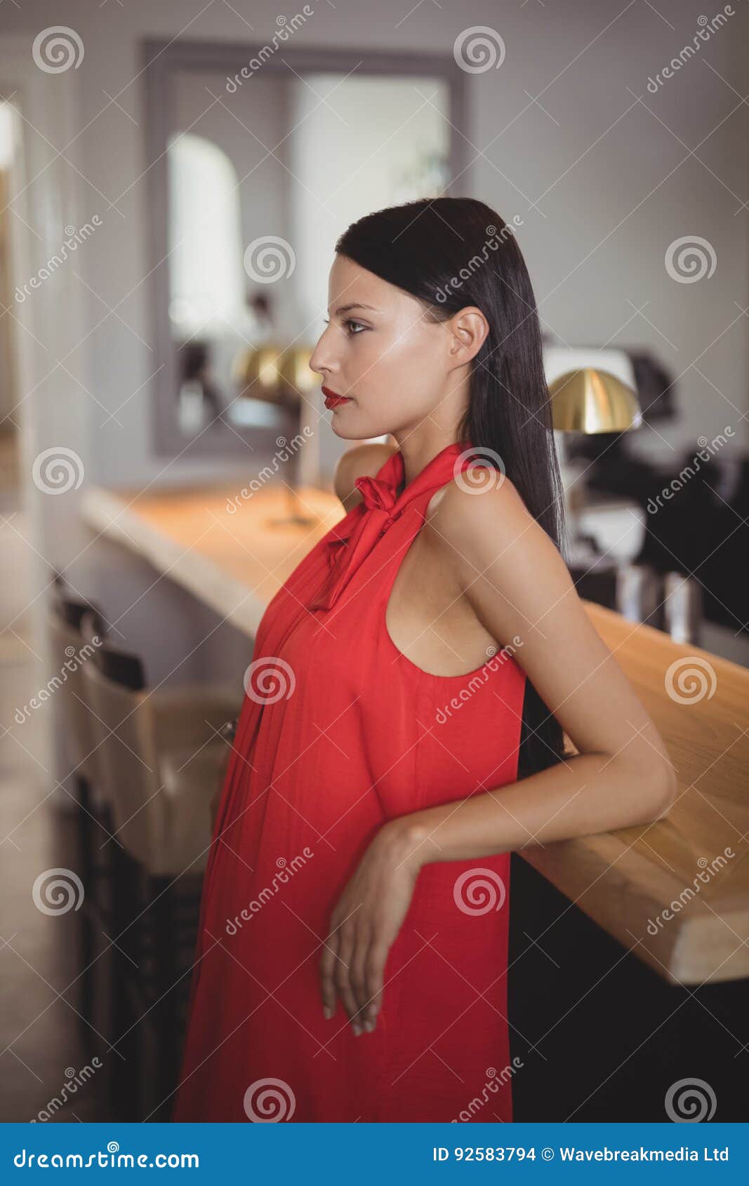 Thoughtful Woman Leaning Against a Counter Stock Photo - Image of ...