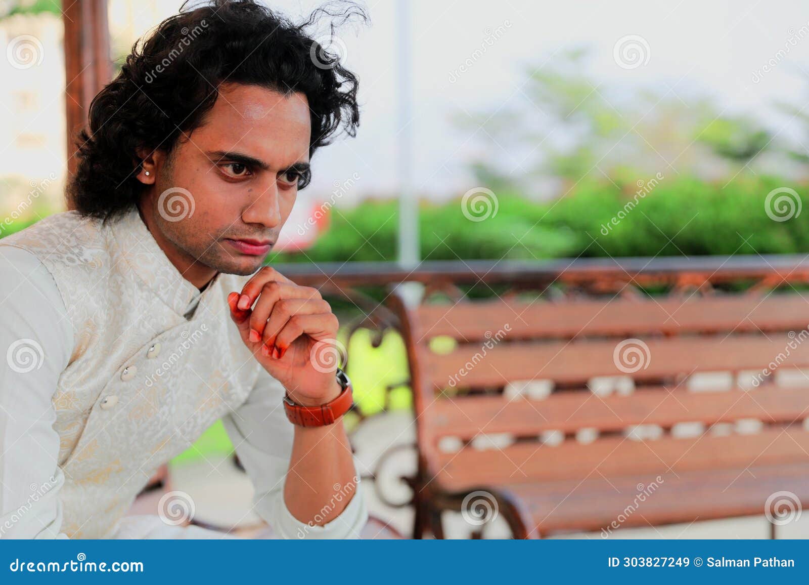 Thoughtful Yong Man in a Deep Thinking Process Sitting on the Bench in ...