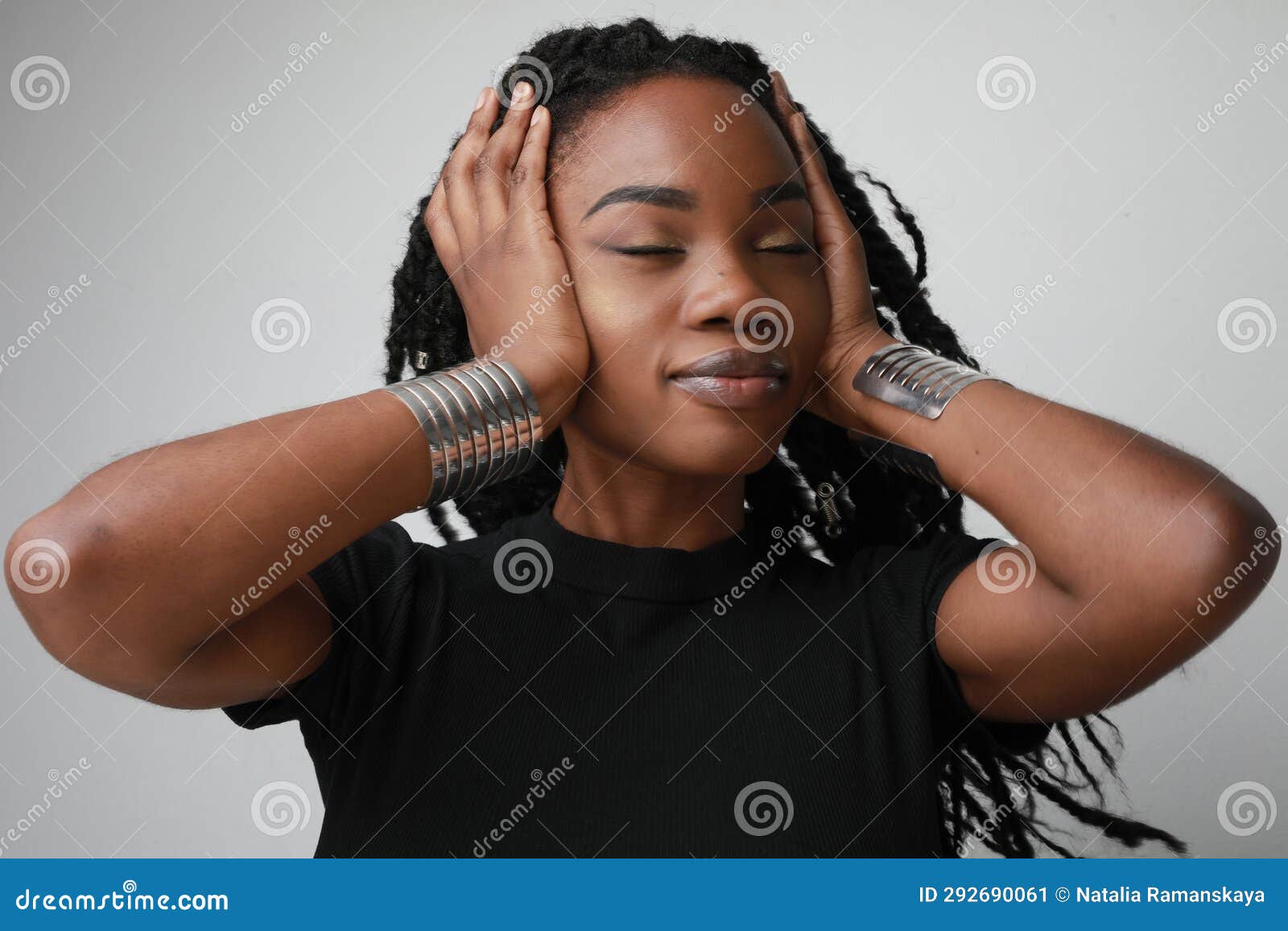 Thoughtful Young African American Woman Covers Her Ears with Hands ... Thoughtful Young African American Woman Covers Her Ears with Hands ...