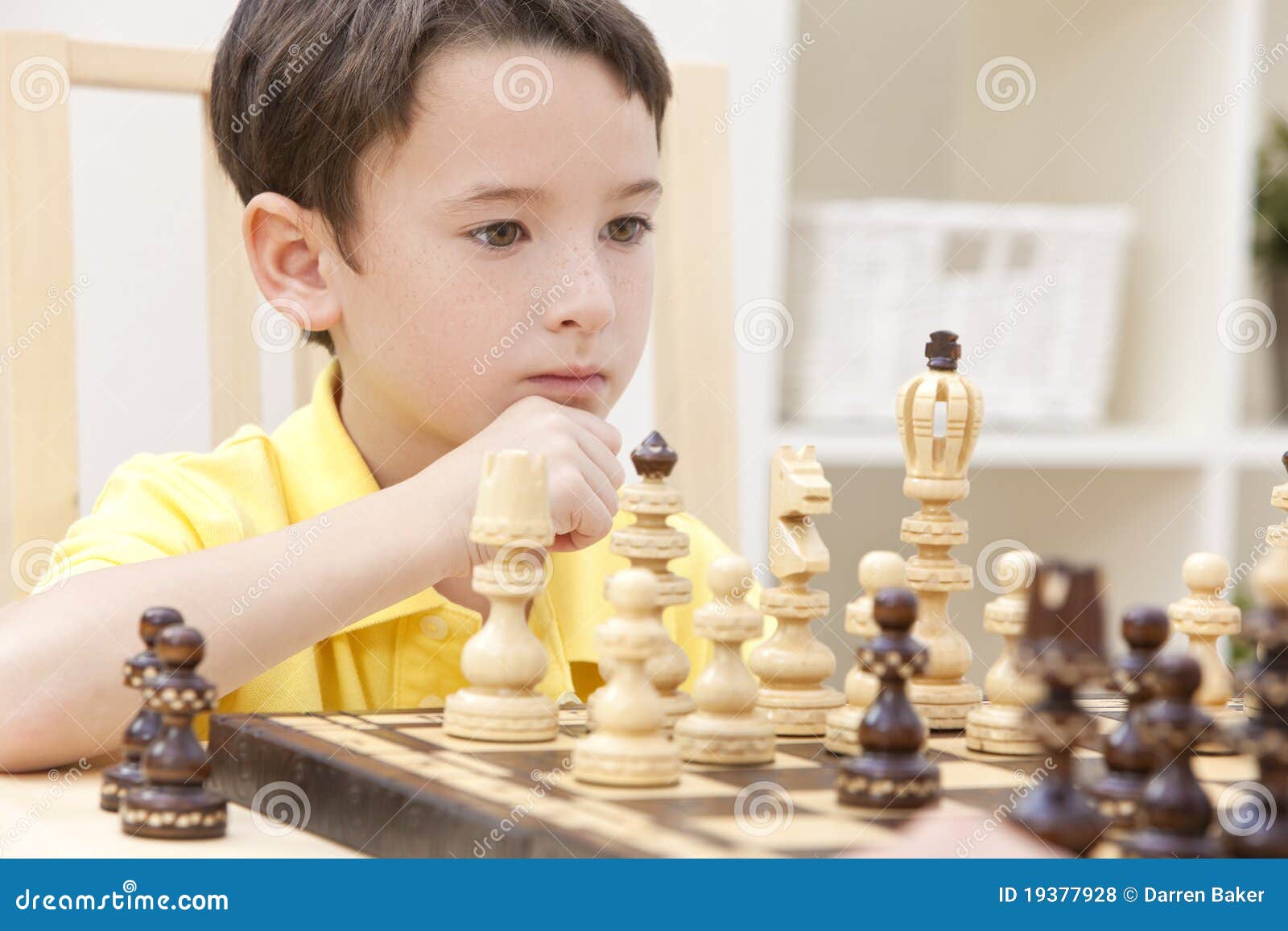 Thoughtful Young Boy Playing Chess Stock Photo - Image of brown, male ...