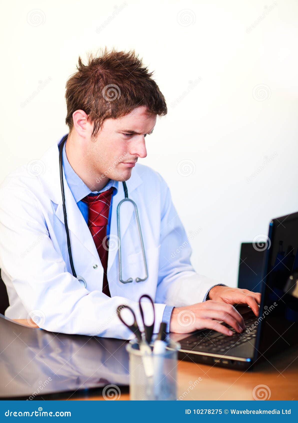 Thoughtful Young Doctor Working on a Computer Stock Image - Image of ...