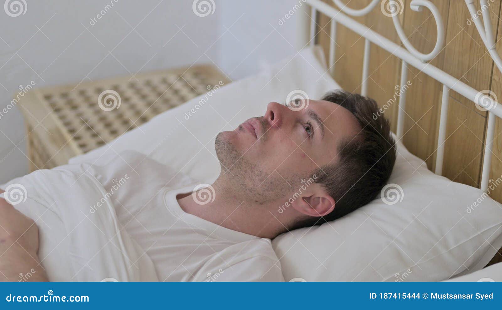 Thoughtful Young Man Awake in Bed Thinking Stock Photo - Image of ...