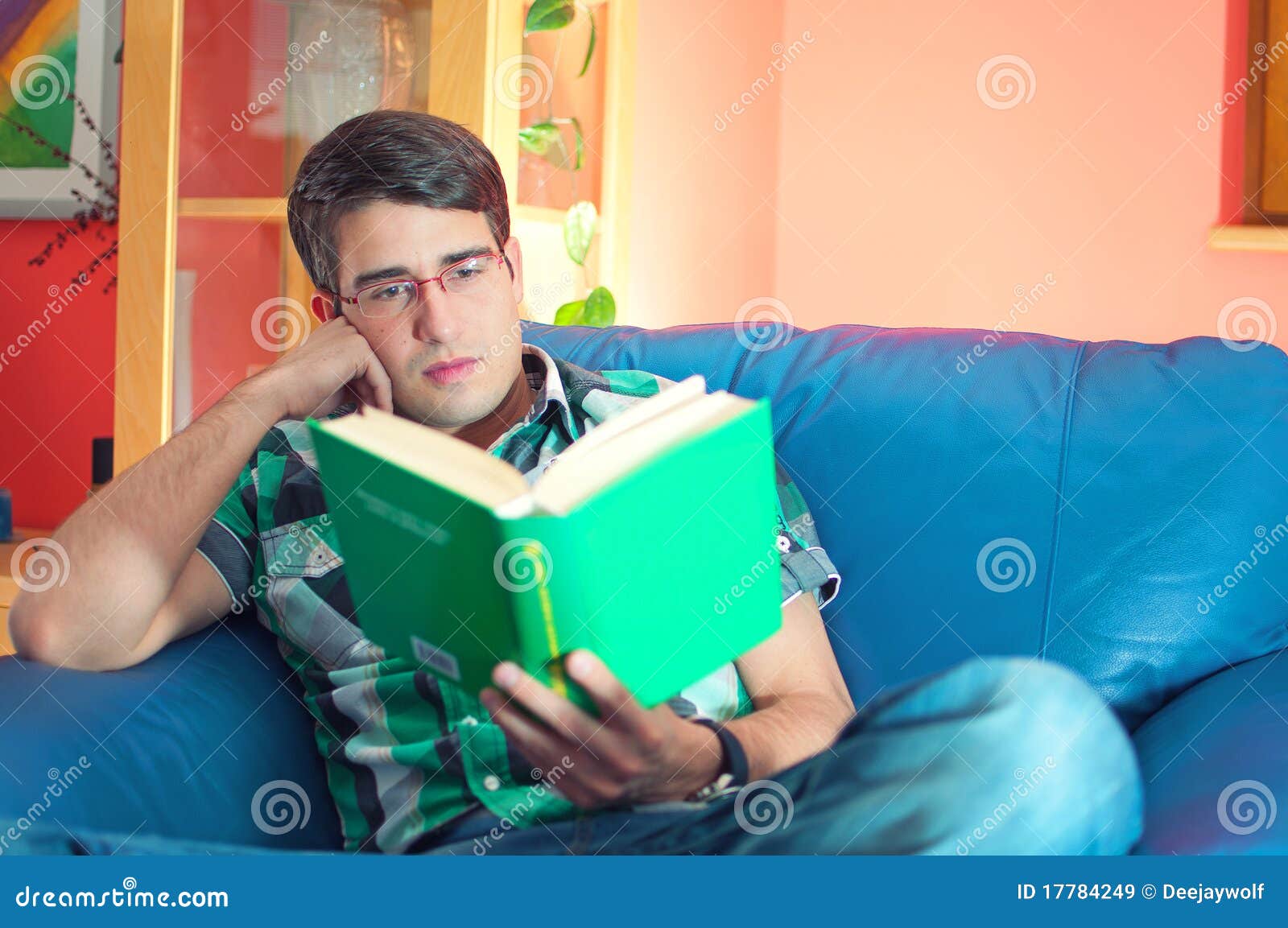 Thoughtful Young Man with Glasses Reading a Book Stock Image - Image of ... Thoughtful Young Man with Glasses Reading a Book Stock Image - Image of ...