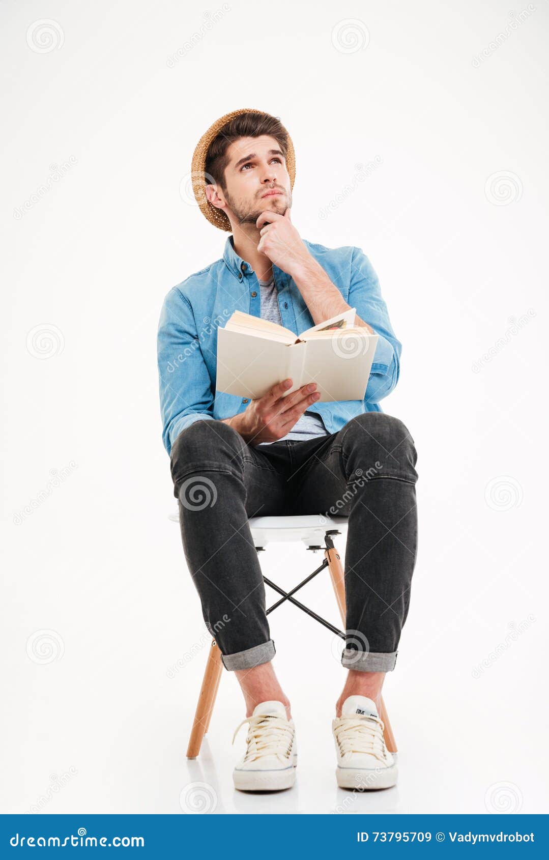 Thoughtful Young Man in Hat Sitting and Reading a Book Stock Image ... Thoughtful Young Man in Hat Sitting and Reading a Book Stock Image ...