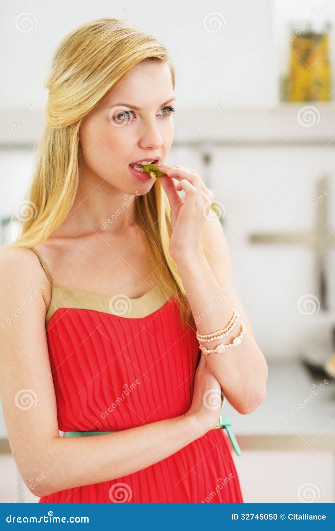 Thoughtful Young Woman Having Snack in Kitchen Stock Photo - Image of ...