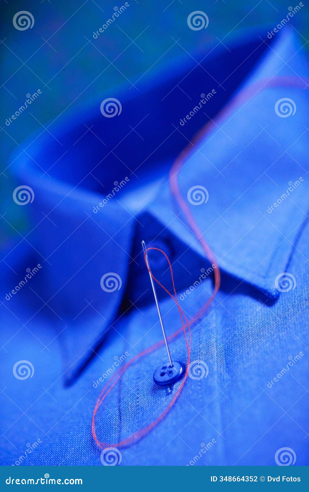 Red Thread and Needle on Blue Shirt Stock Photo - Image of needle ...