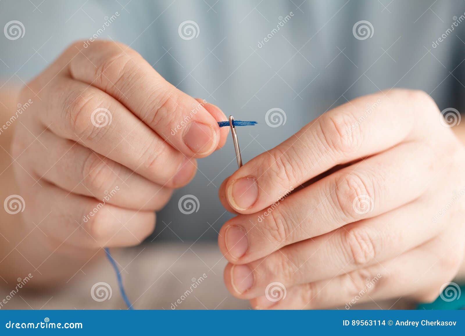 Thread into the Needle. Close-up of Man Pulling Thread into the Stock ...