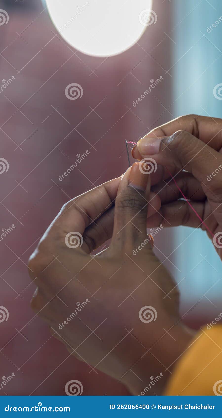 Thread into the Needle. Hands of Woman Pulling Thread into the Needle ...