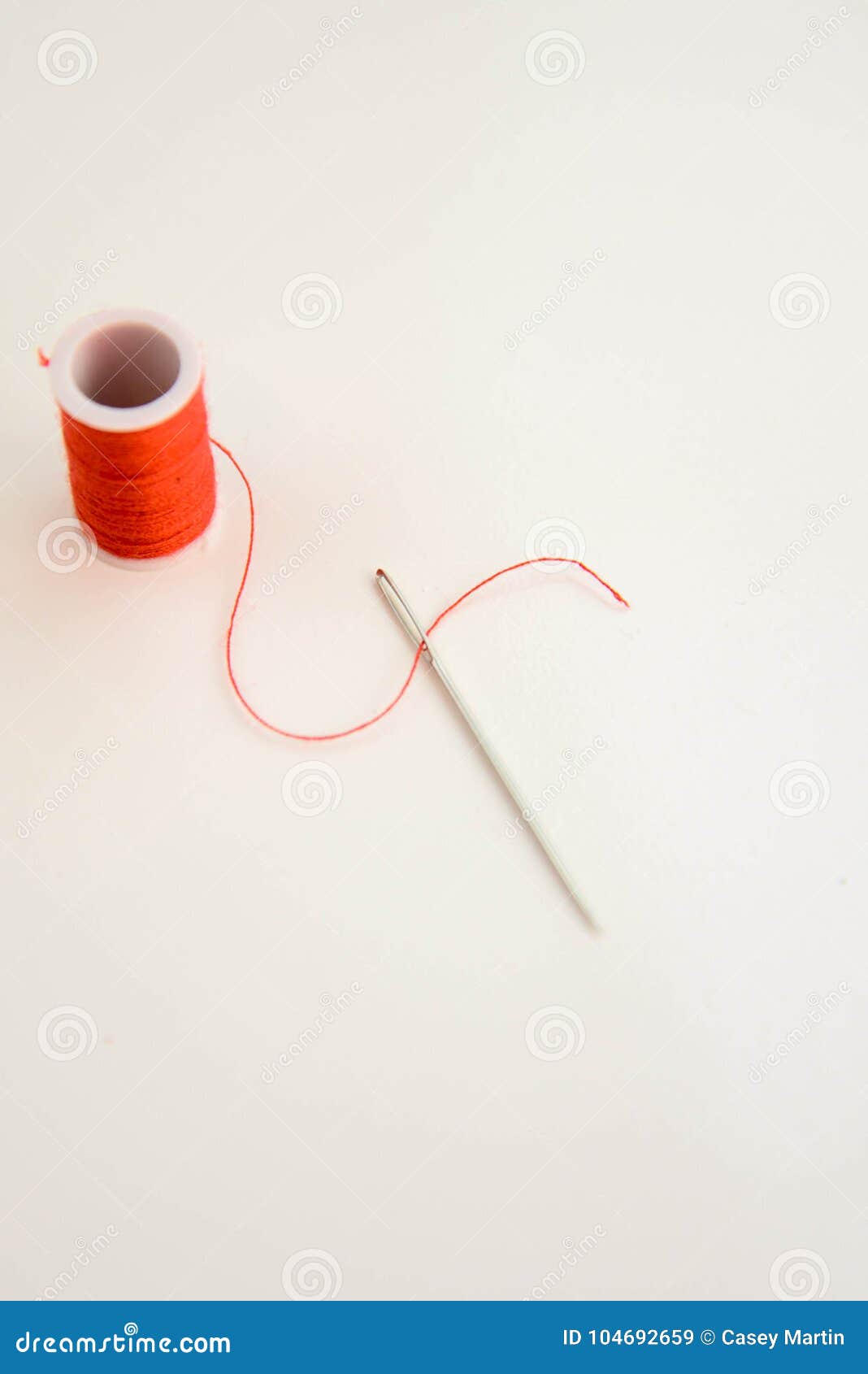 Threaded Needle and Red Spool of Thread Stock Image - Image of ...