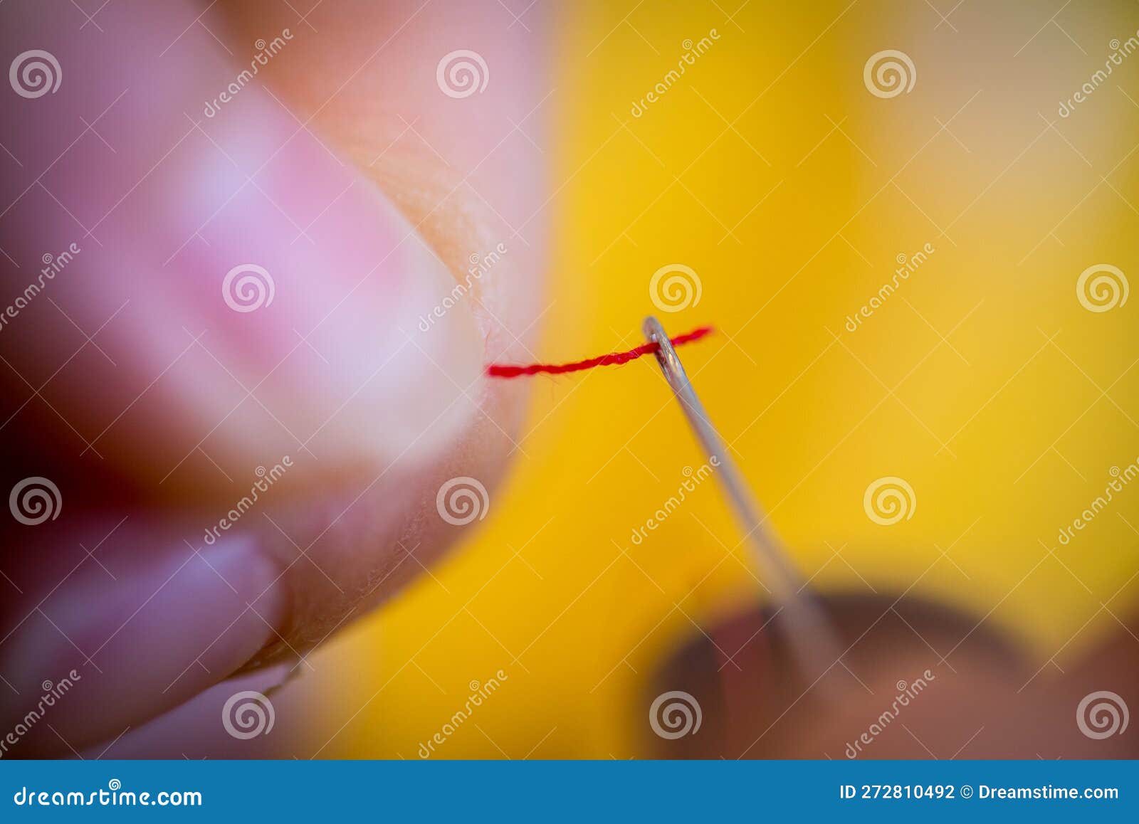 Threading a Needle with Red String Stock Photo - Image of needle ...