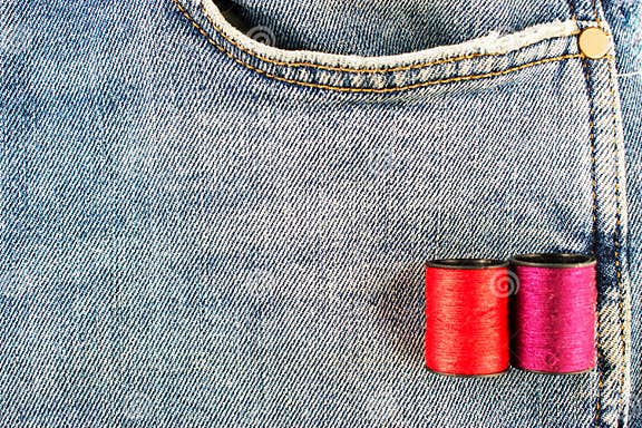 Threads on the Background of Jeans. Blue and Red Thread on the ...